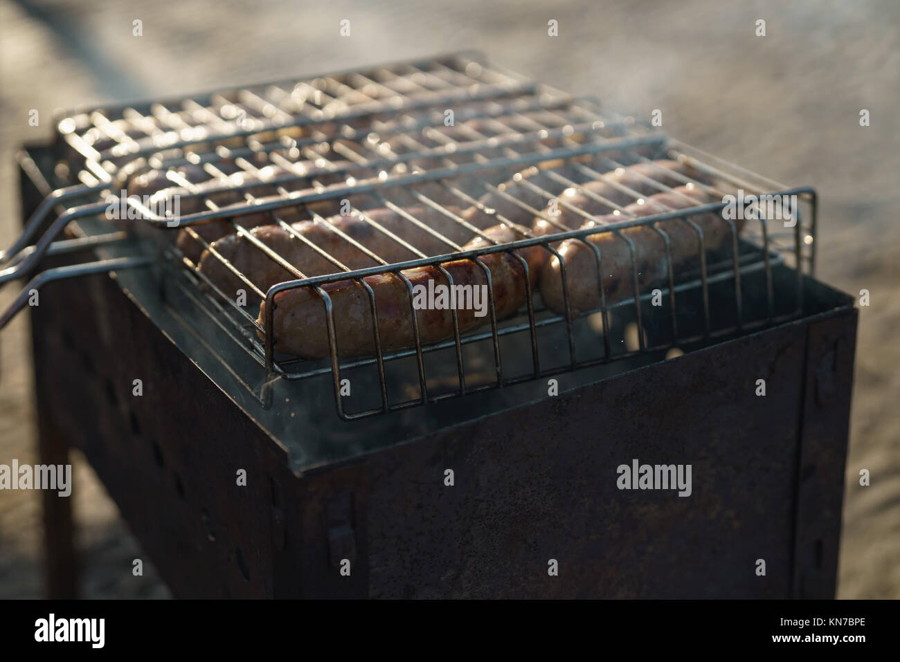 cooking bbq sausages on a beach, shallow focus Stock Photo - Alamy