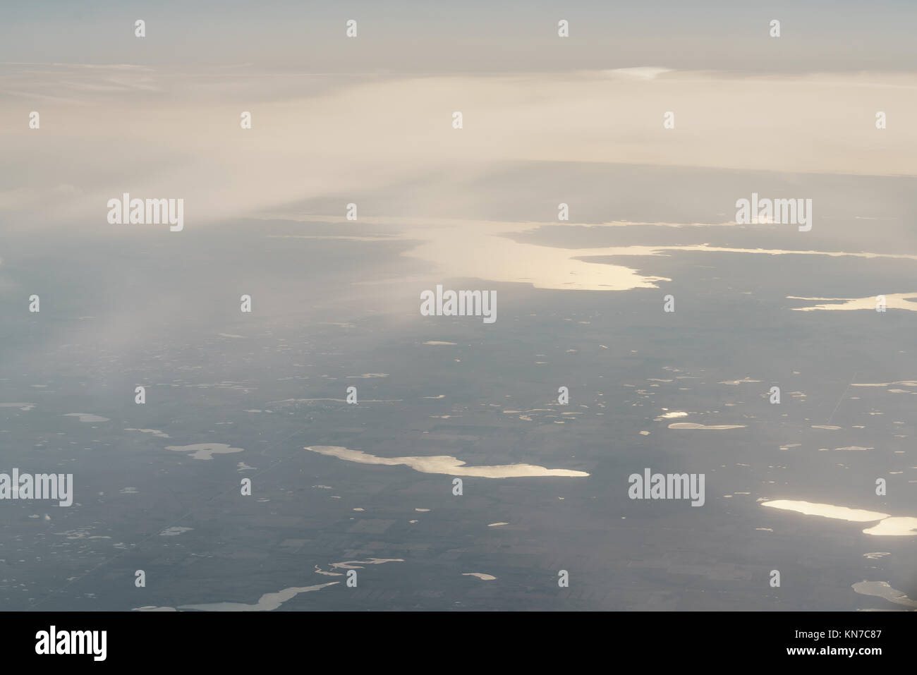 view of fields and rivers from airplane flying over USA, high angle ...