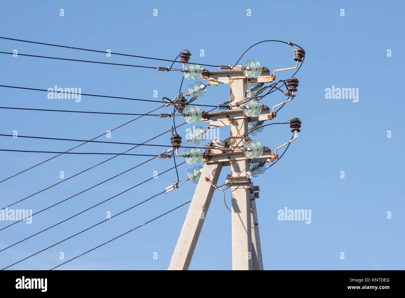 A pillar of power line installed on it, and isolated wires to prop up ...