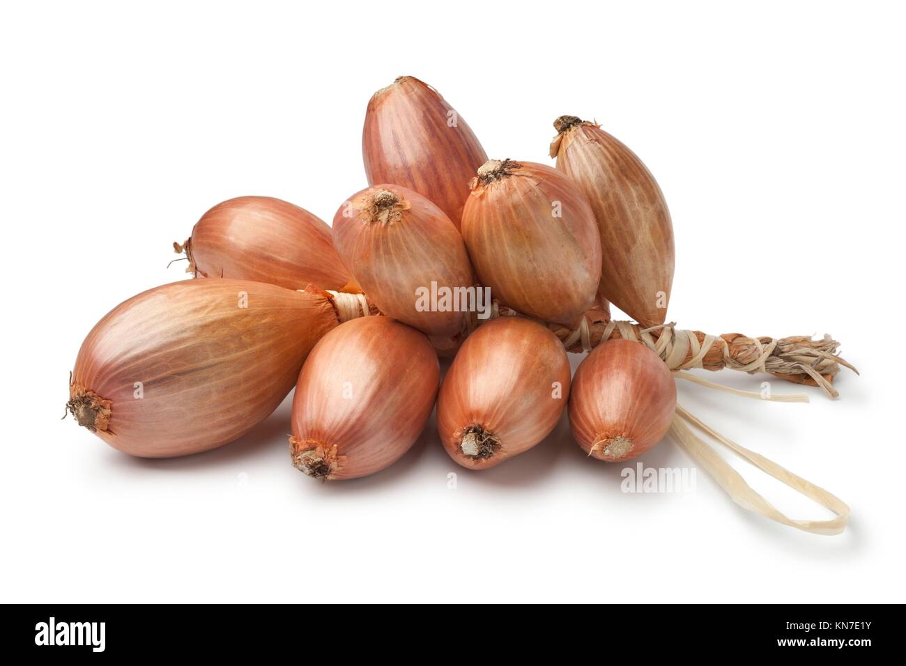 Bunch of fresh brown french shallots on white background Stock Photo ...
