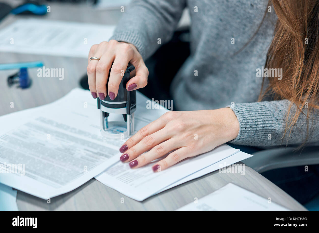 girl puts a stamp on documents in the office Stock Photo - Alamy