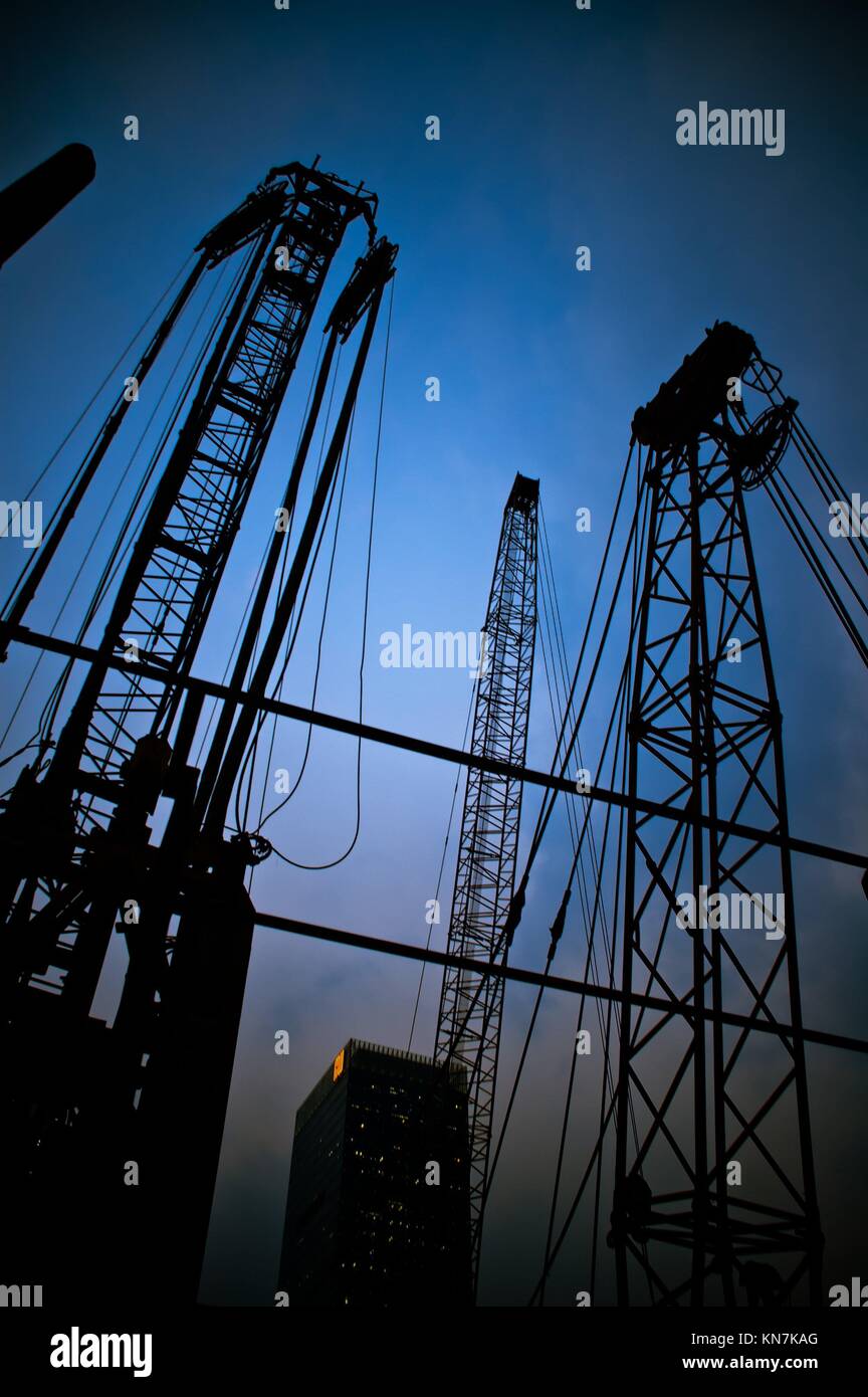 construction cranes on night ove a blue sky Stock Photo - Alamy