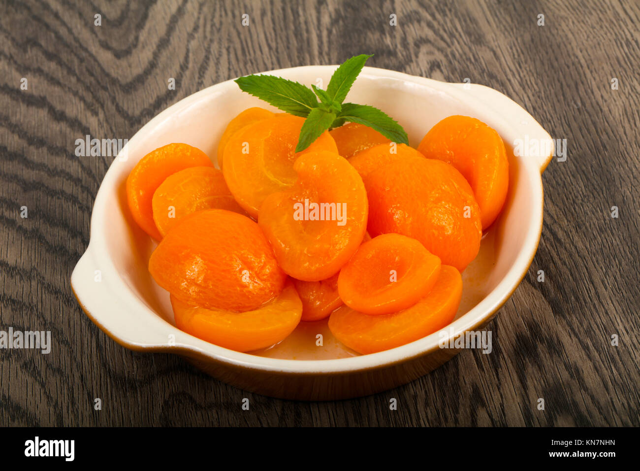 Canned apricots with mint leaves Stock Photo - Alamy
