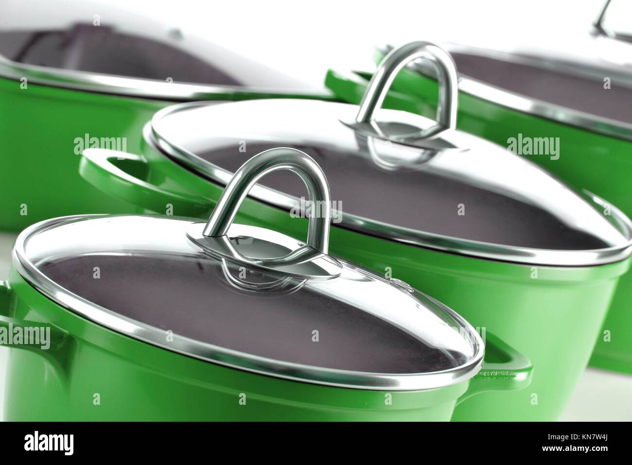 Composition with four steel kitchen pots Stock Photo - Alamy
