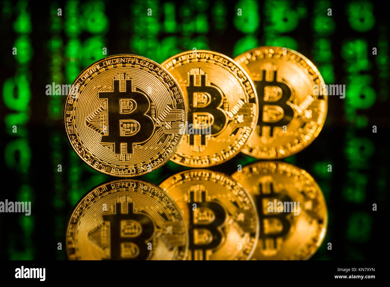 Golden bitcoins. Cryptocurrency in front of green matrix background ...