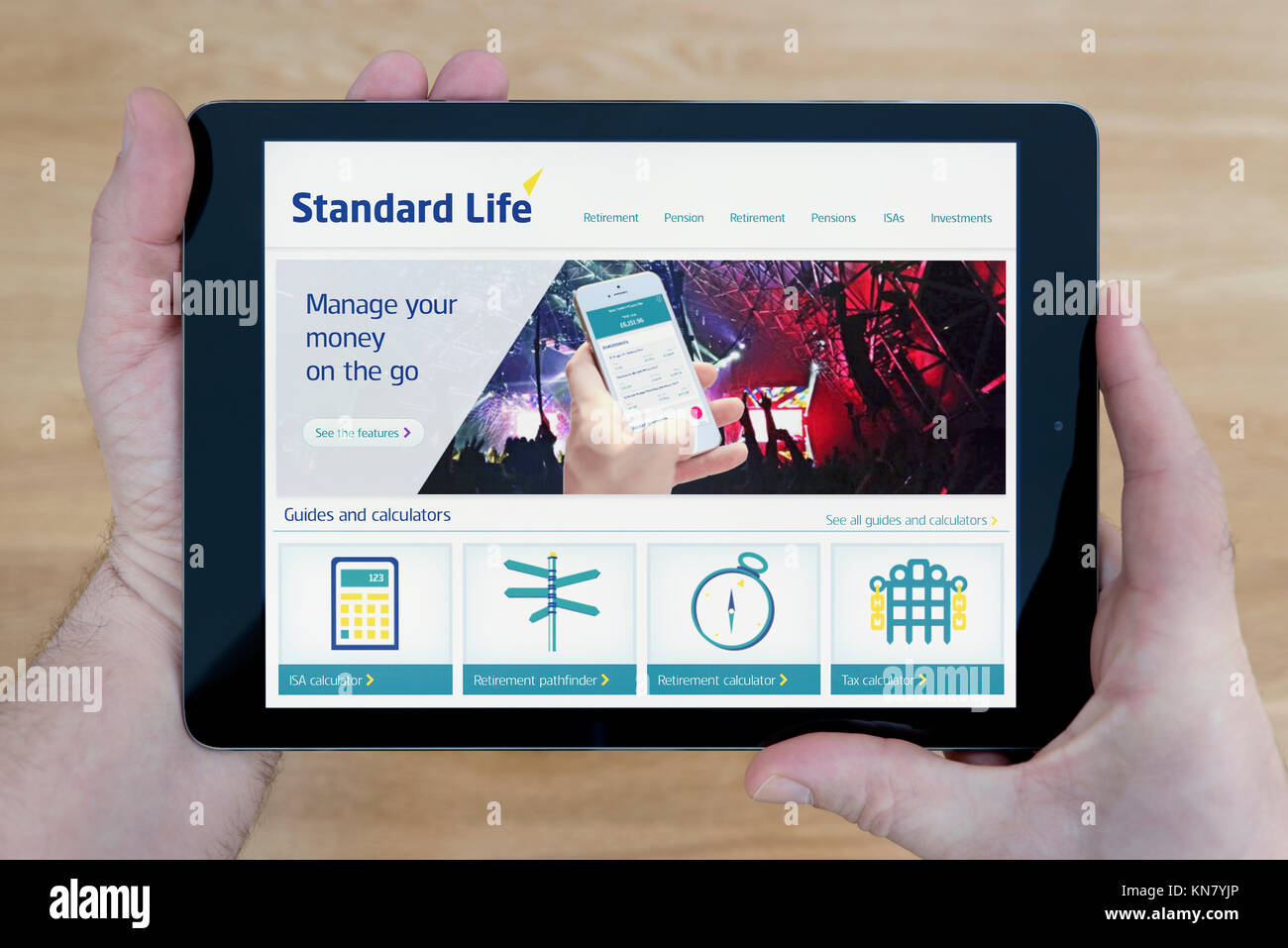 man looks at the Standard Life website on his iPad tablet device, shot ...