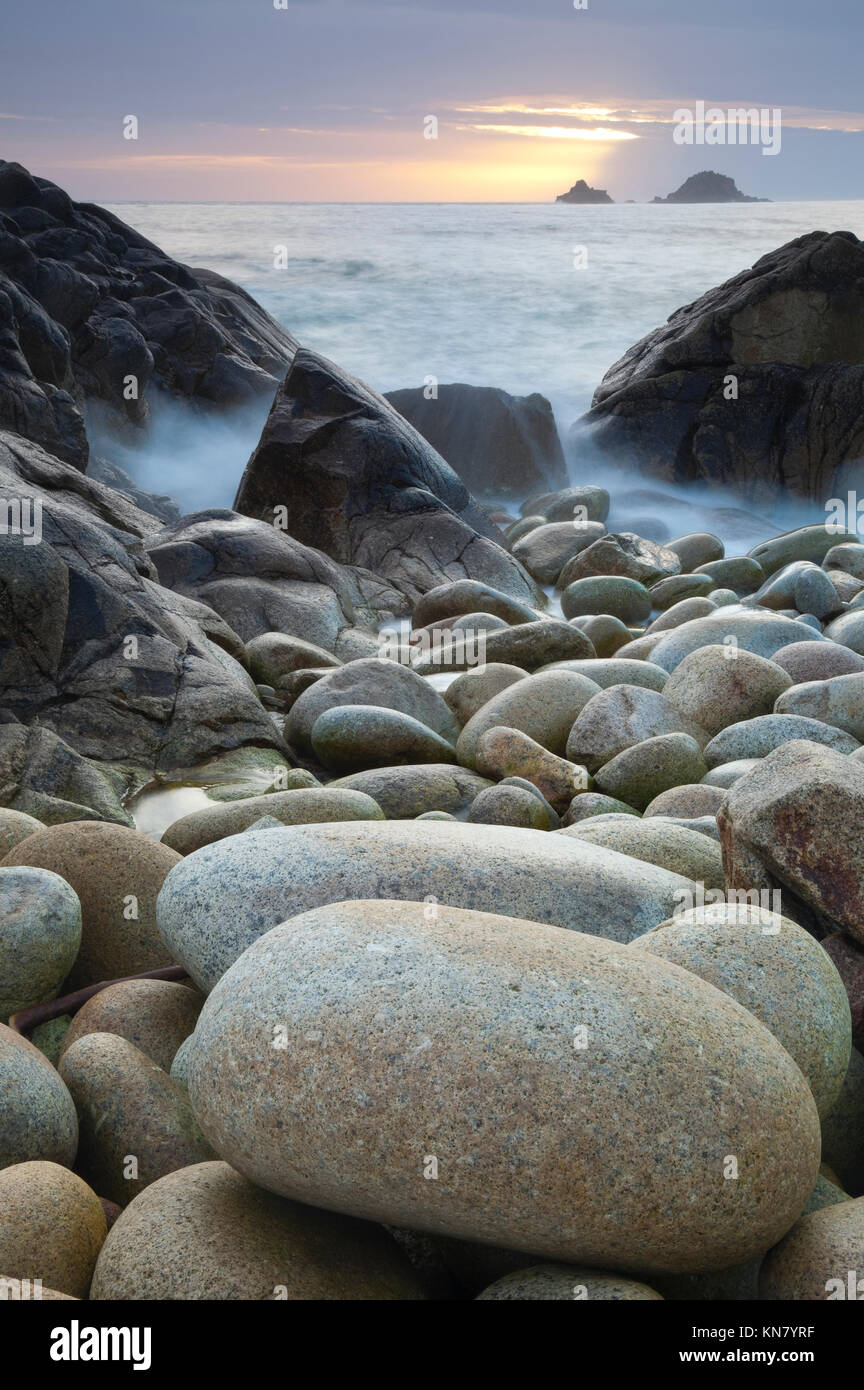 West Cornwall ocean at sunset with moving water rolling over large ...