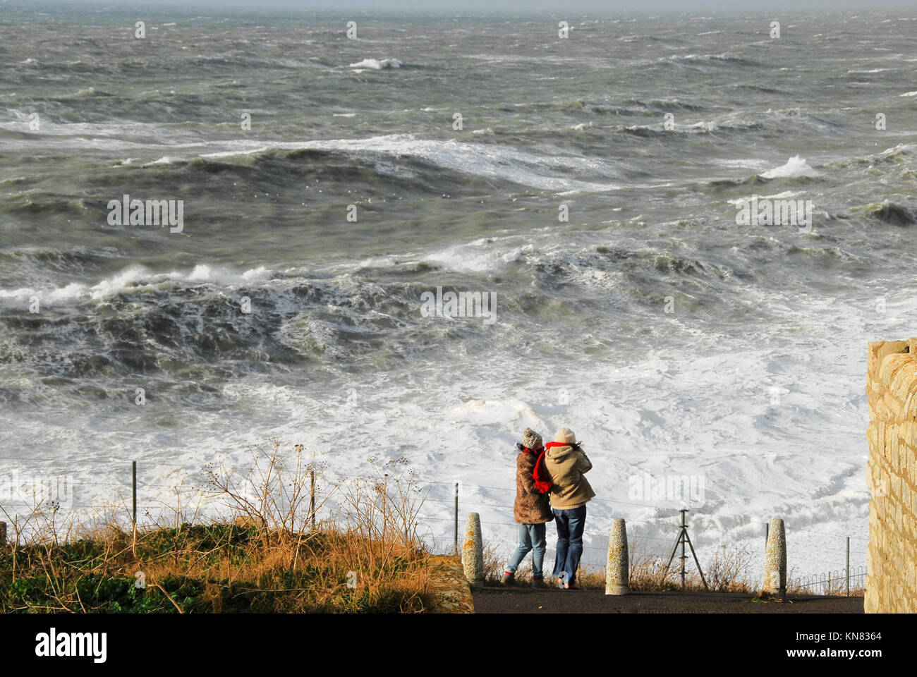 Chesil Beach, Portland, Dorset. 10th December 2017 - Two women watch ...