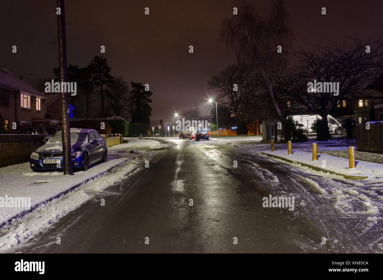 A suburban street seen at night after a day of snow which has left ...