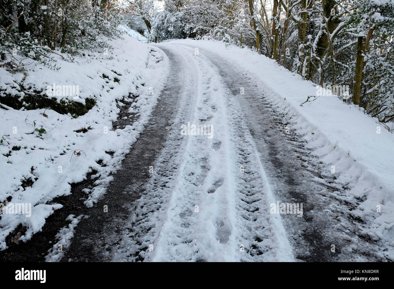 Tire tracks and footprints in snowy road hi-res stock photography and ...