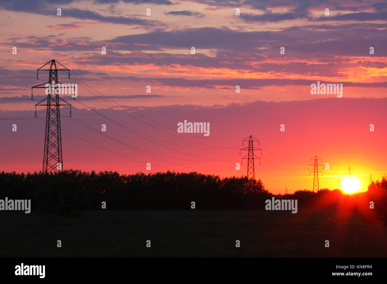 Pylons at sunset Stock Photo - Alamy