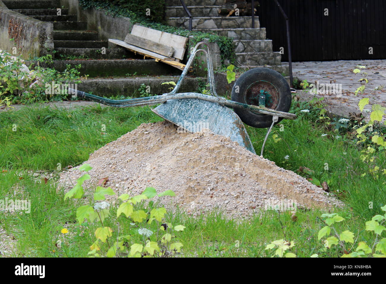 Heavily used construction cart with two handles and single wheel turned ...