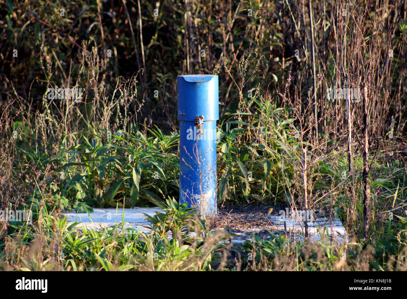 Strong industrial metal blue pipe with padlock locked cap on hard ...