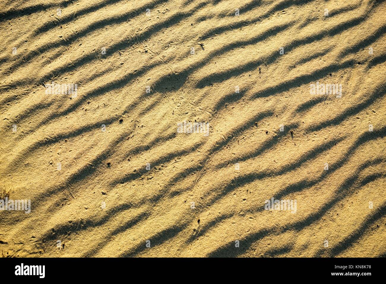 Natural background of a yellow sand with waves Stock Photo - Alamy