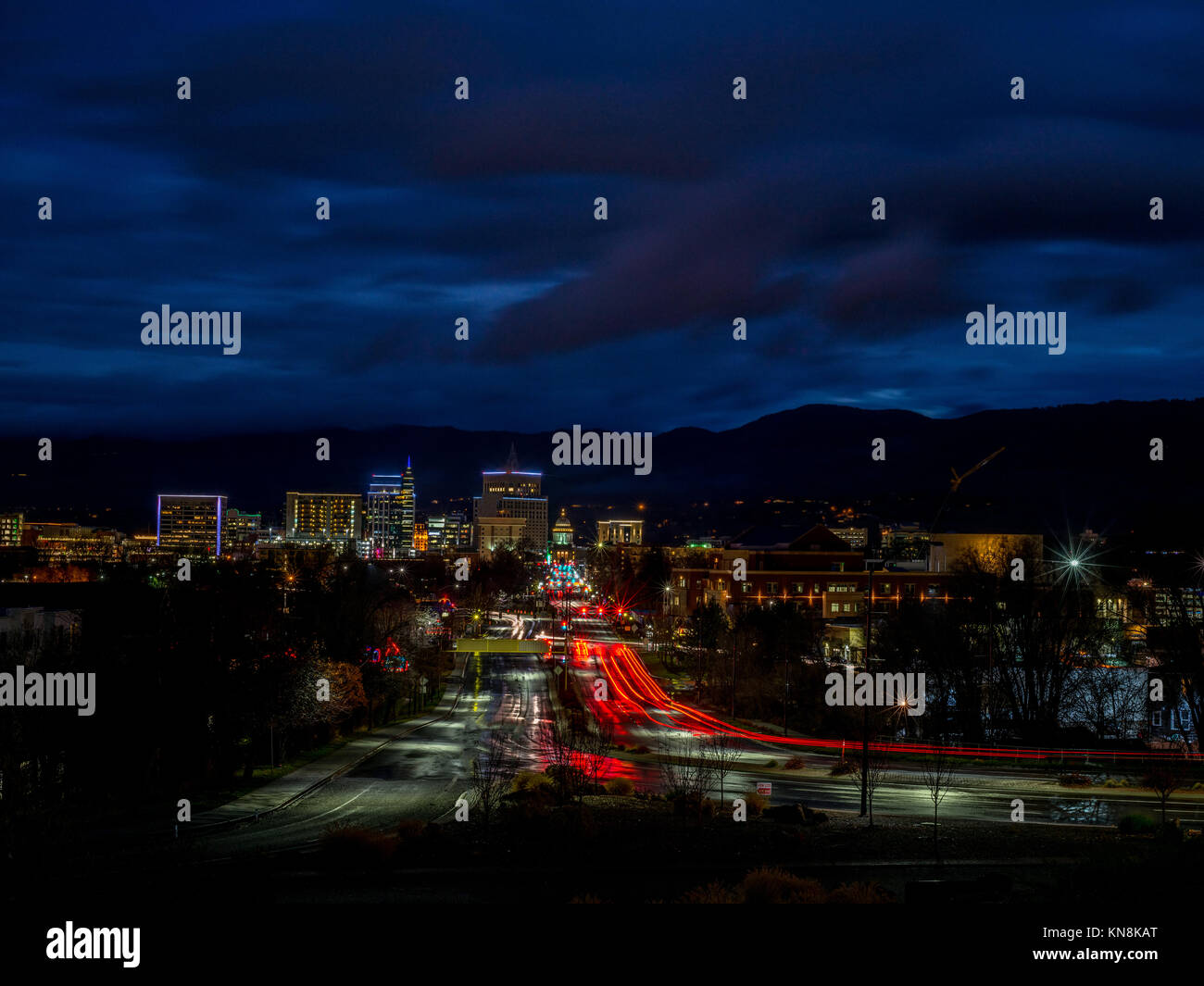 Early morning night sky over the city of Boise Idaho with cars driving ...