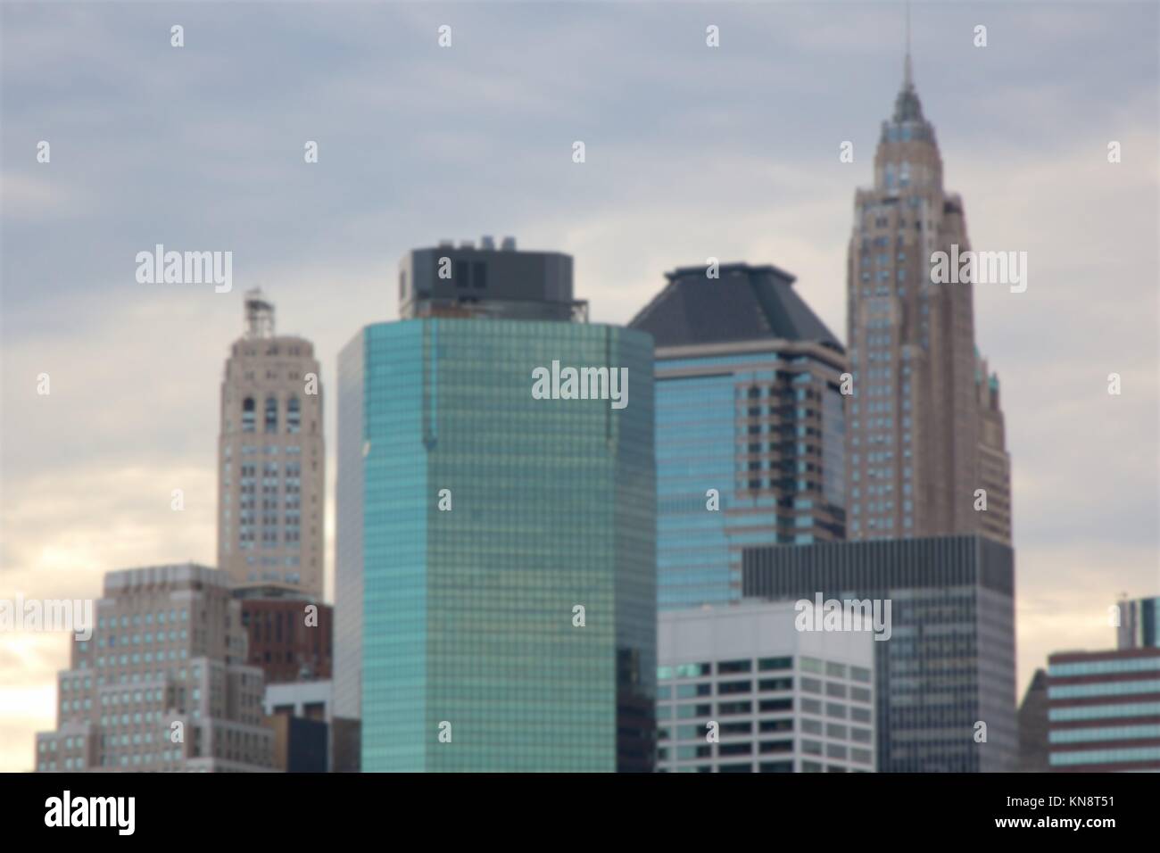 Blurred background of towers in downtown Manhattan set against evening ...