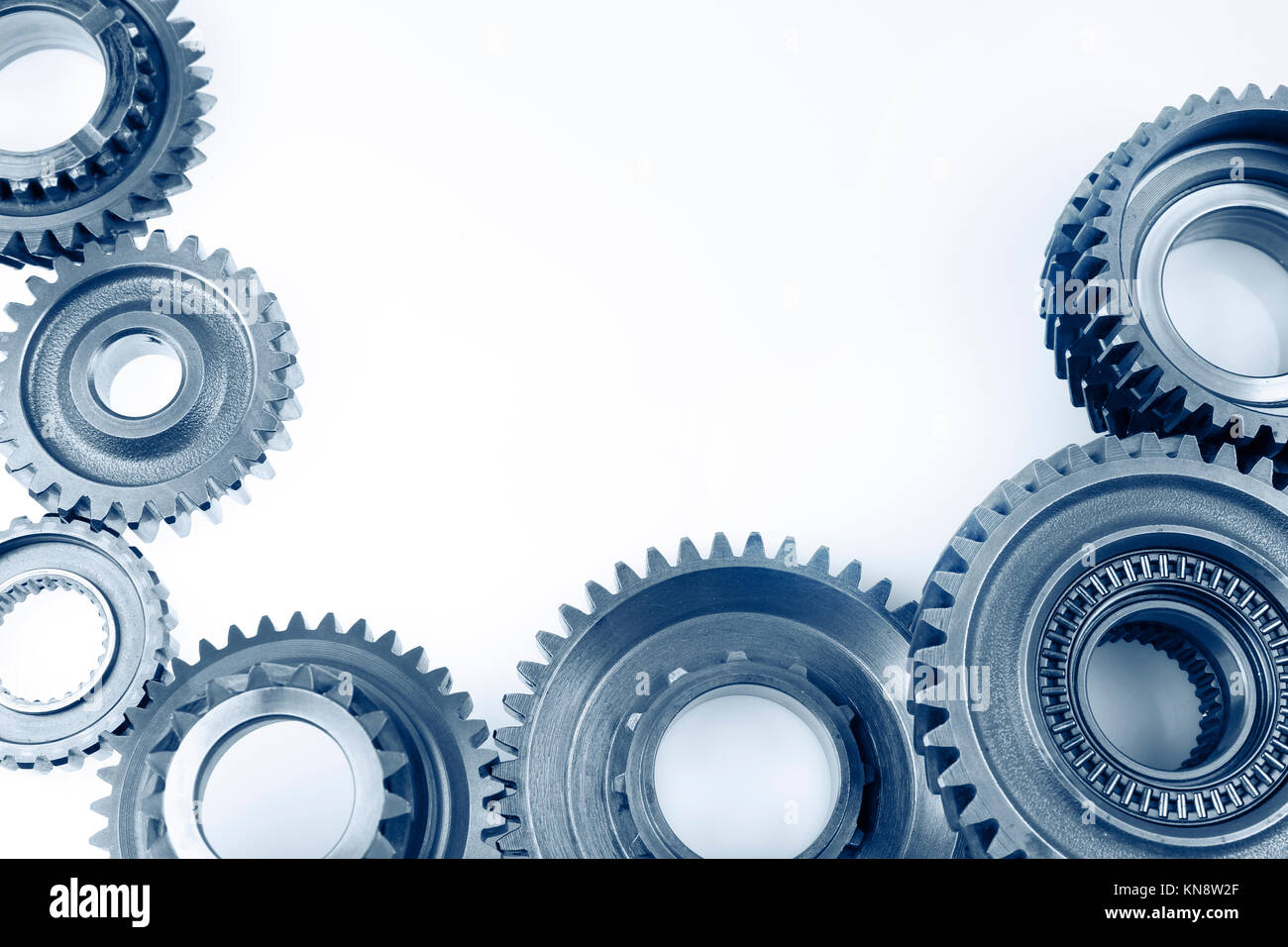 Metal cog wheels bonding together Stock Photo - Alamy