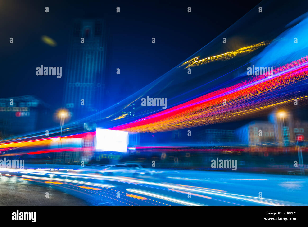 blurred traffic lights on road in central district at night Stock Photo ...