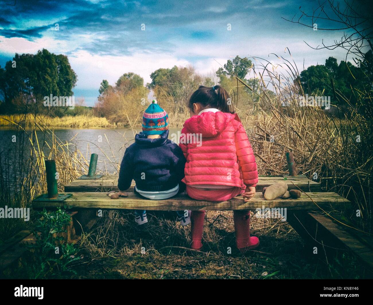 Children Throwing Stones Into The River High Resolution Stock ...