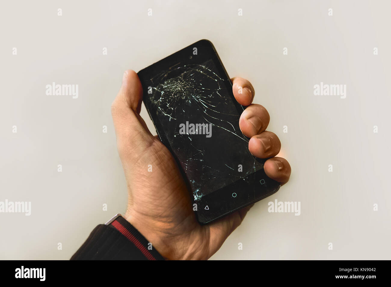Man hand holding mobile phone with broken screen Stock Photo - Alamy