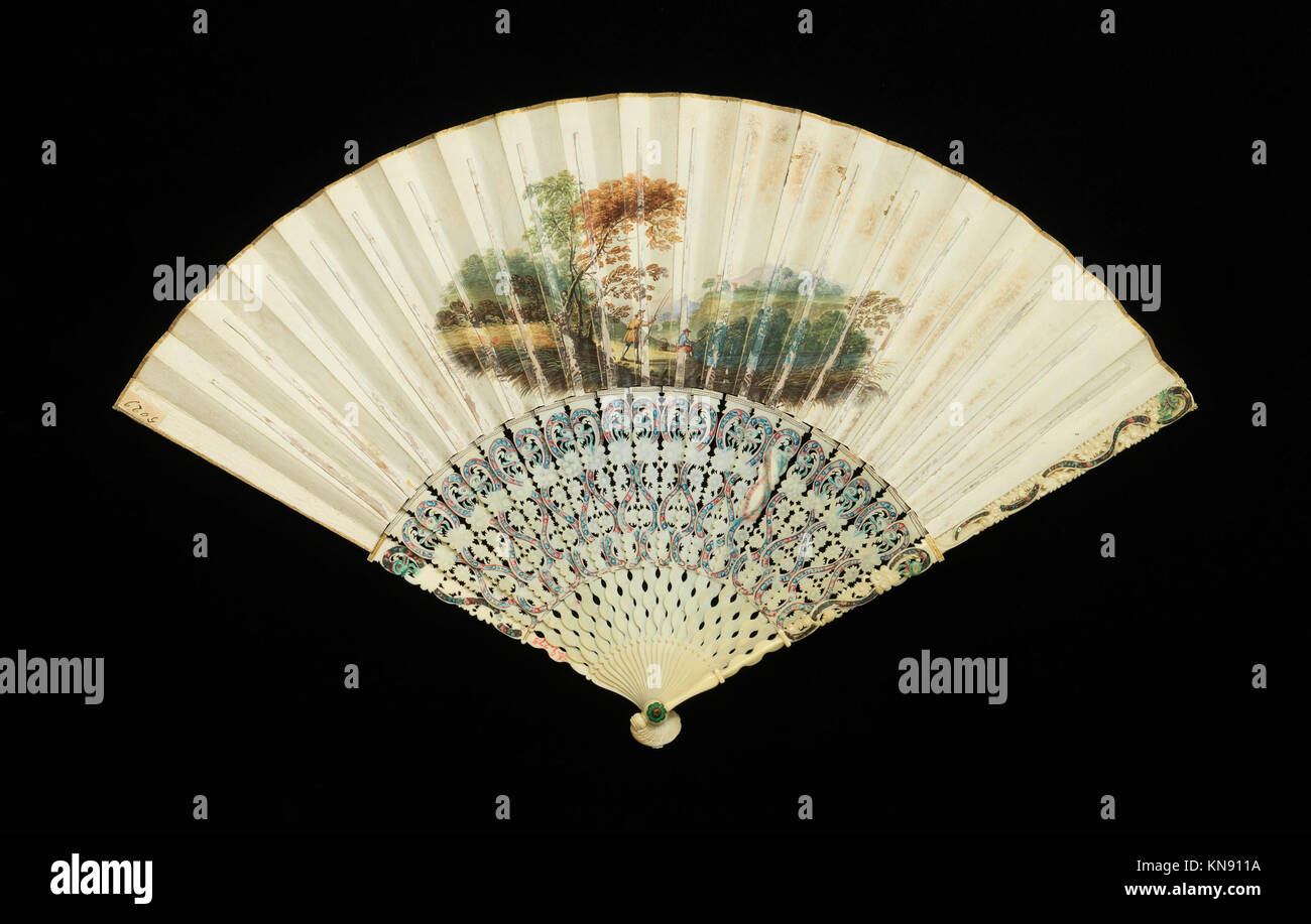 A decorative fan, showcasing intricate design work. The fan reflects ...