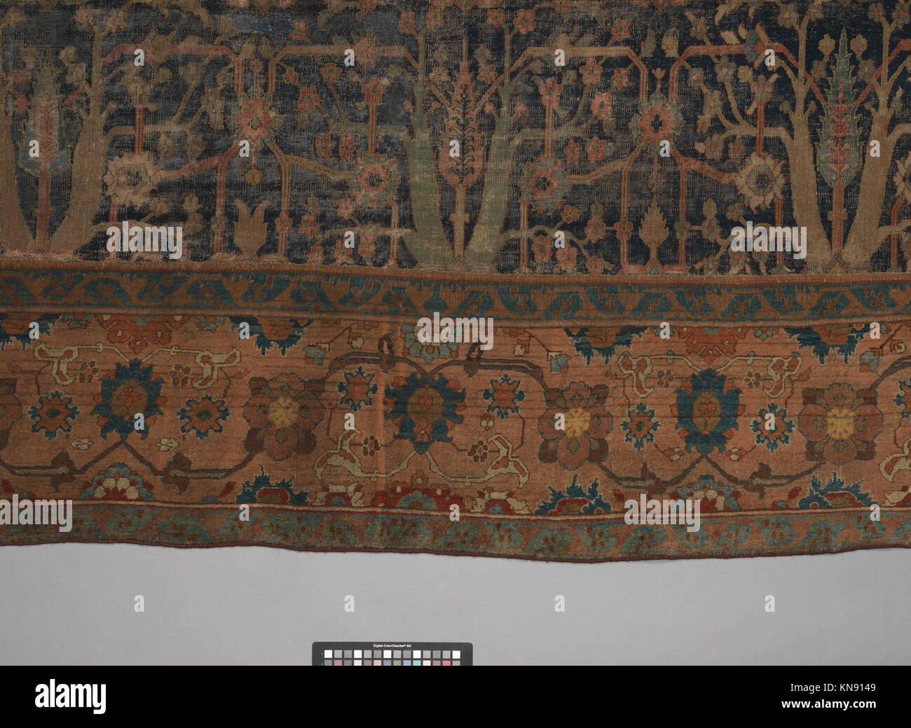 This carpet features a repeating tree design, showcasing intricate ...