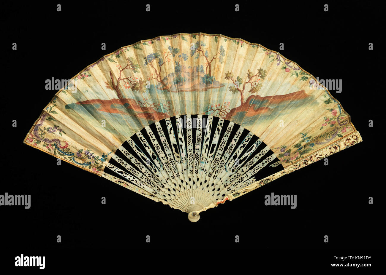 A decorative hand fan, crafted with intricate designs. It exemplifies ...