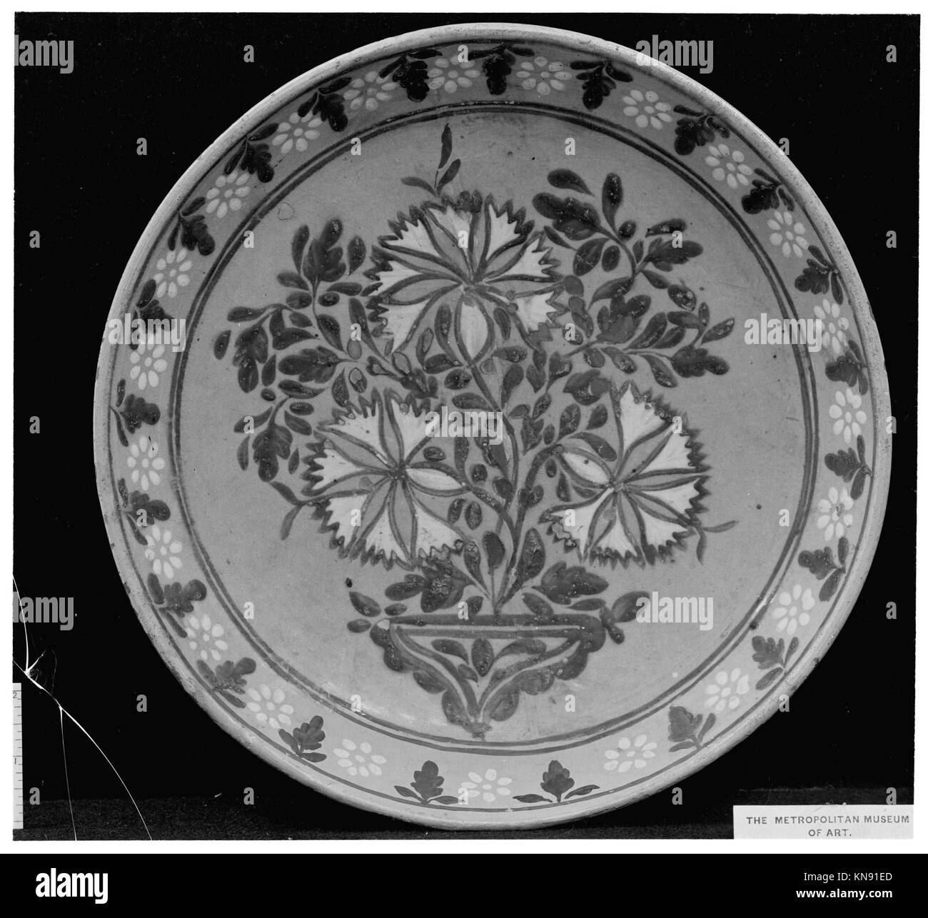 This dish, a fine example of ancient craftsmanship, features intricate ...