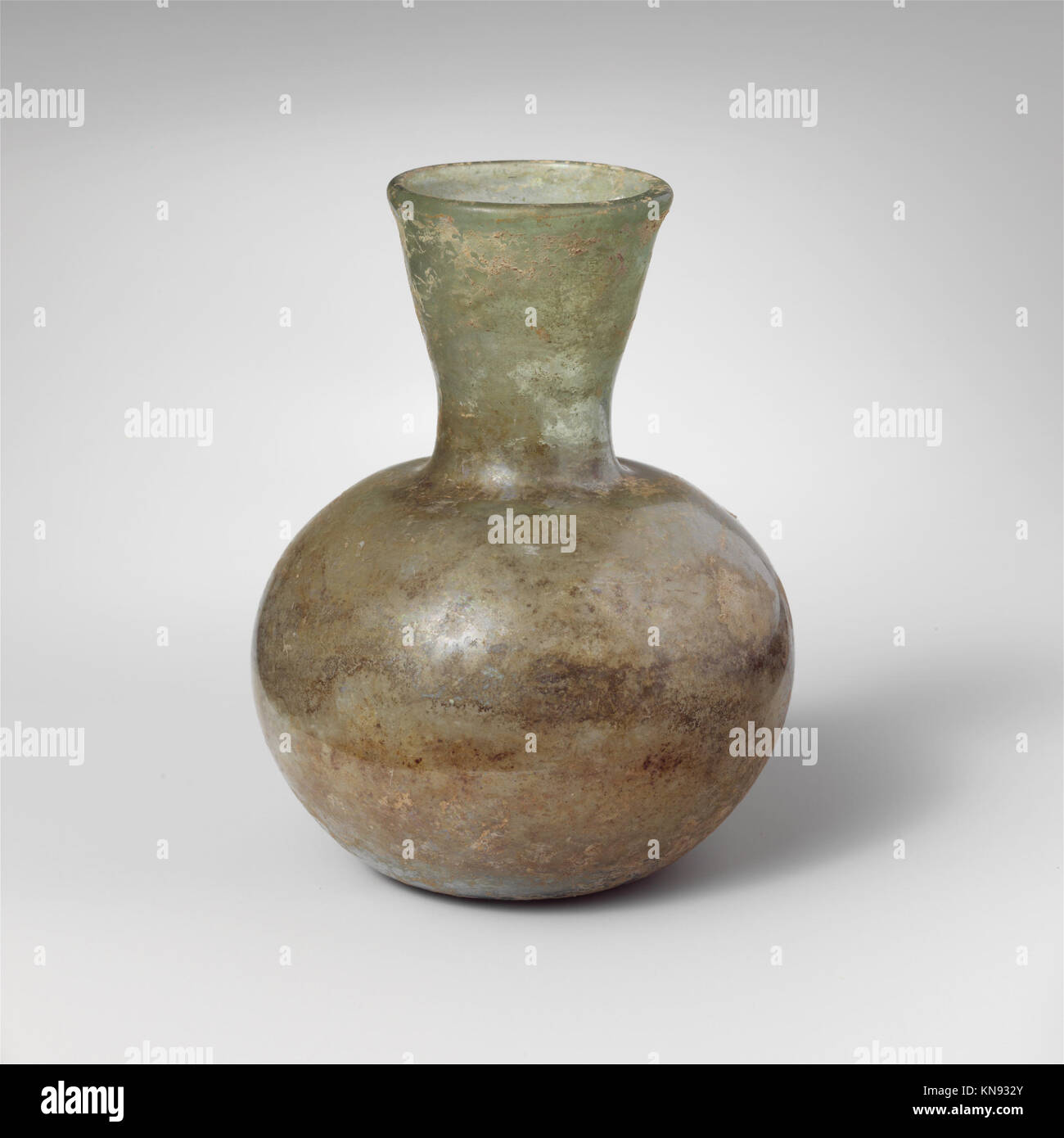 This glass flask is an ancient container, possibly used for storing ...