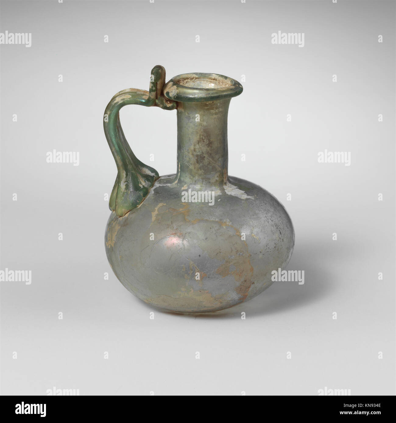 This glass jug, part of a collection of ancient glassware, features ...