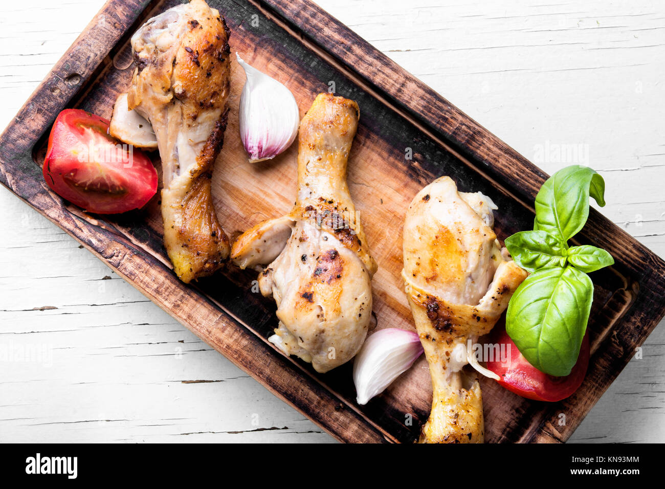 chicken legs on kitchen board in light background Stock Photo - Alamy