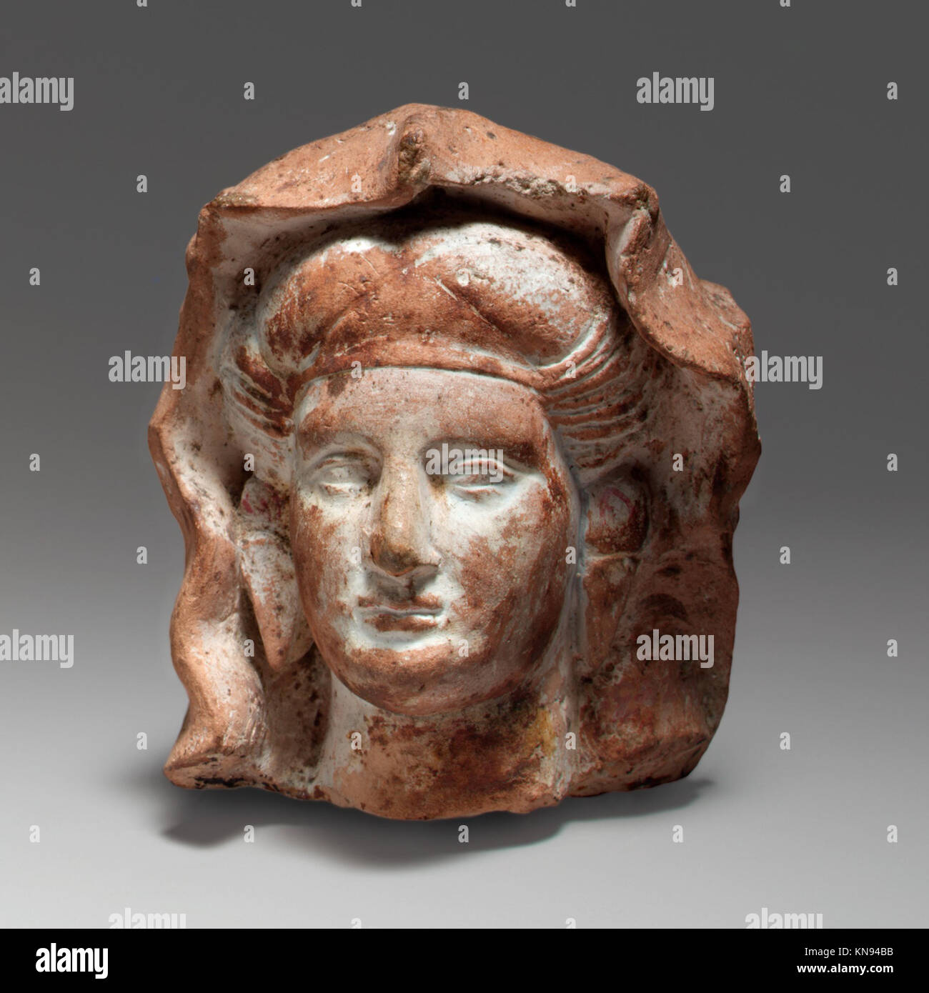 This sculpture represents a female head, possibly of a goddess. It is ...