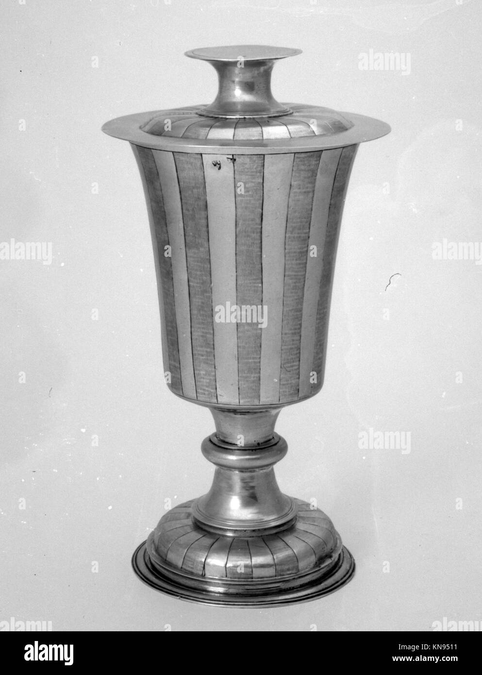 This communion cup and paten are religious ceremonial objects made from ...