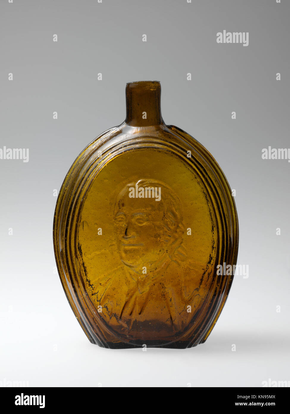 This figured flask features intricate designs, likely used for holding ...