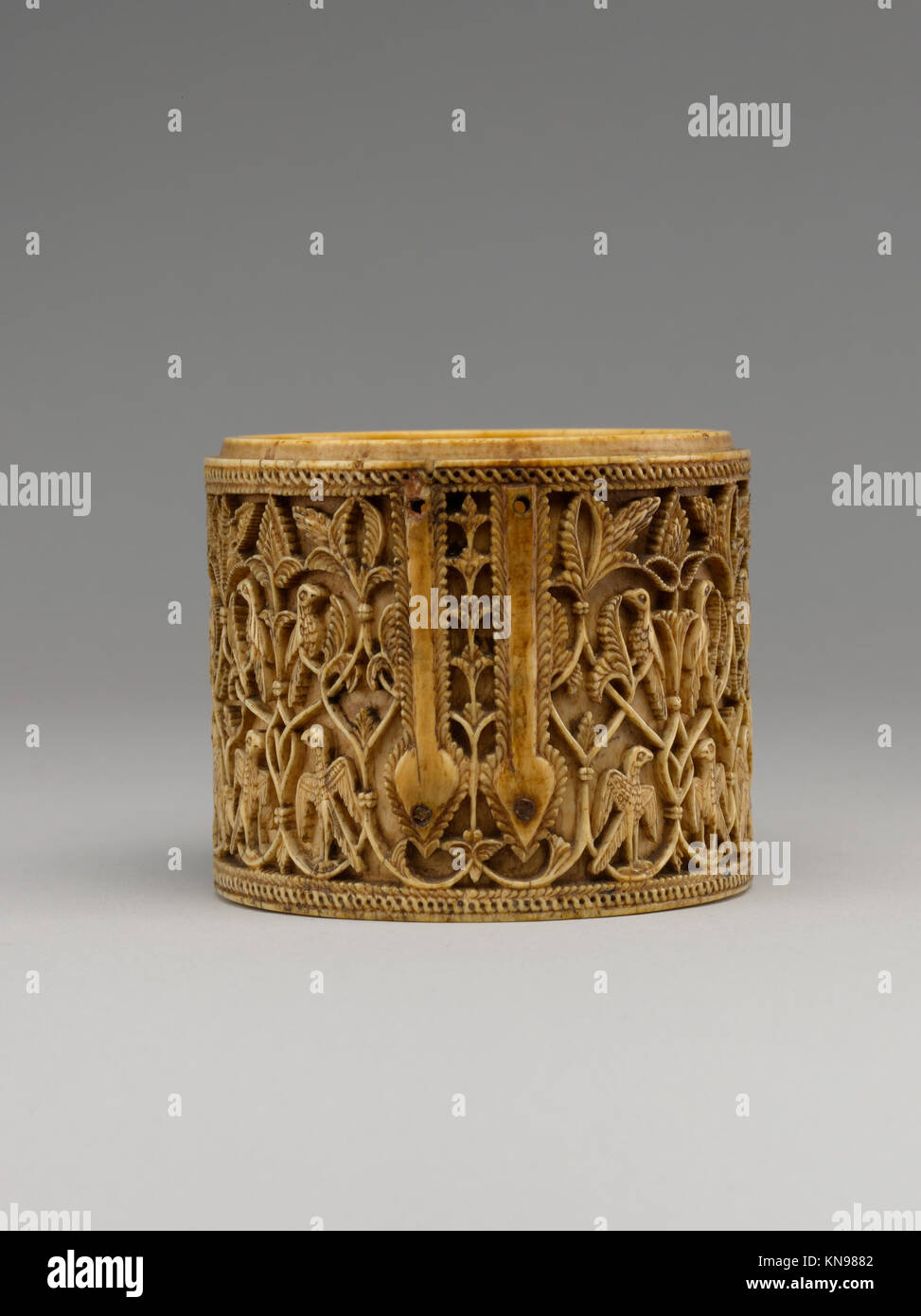 This ancient pyxis, a cylindrical container, holds small personal items ...