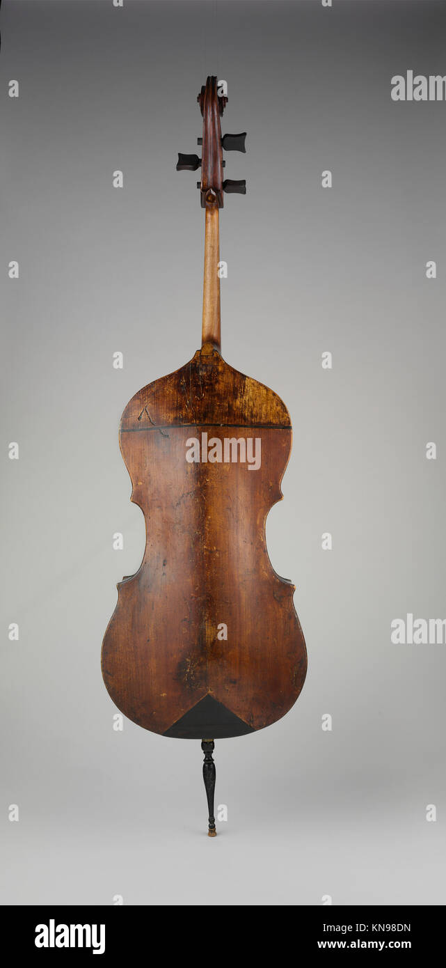 This double bass, a string instrument known for its large size and deep ...