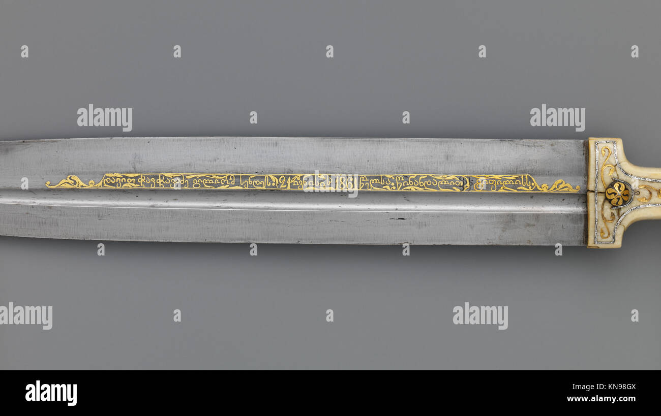 This qama dagger features a curved blade, typical of the region's ...