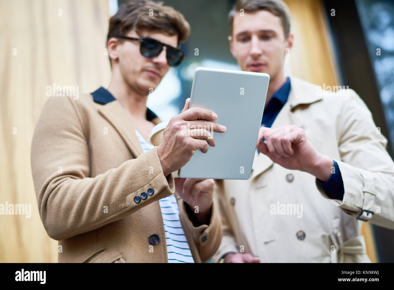 Two happy young men using hi-res stock photography and images - Alamy