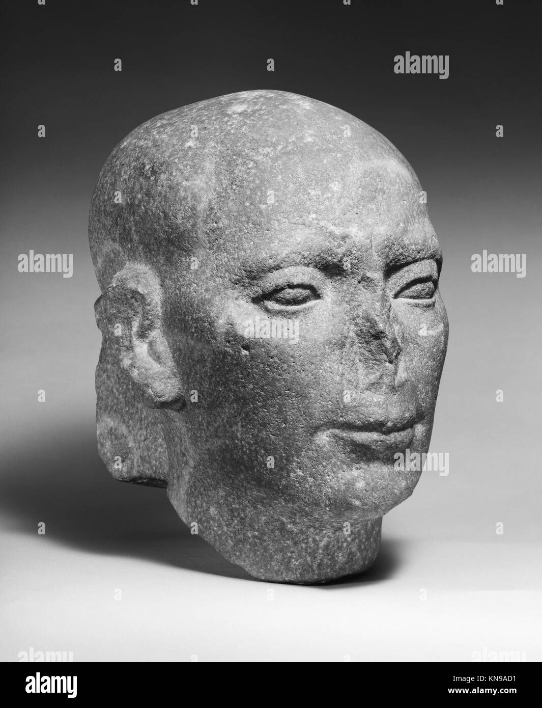 A head fragment from a large statue, likely representing a priest or ...