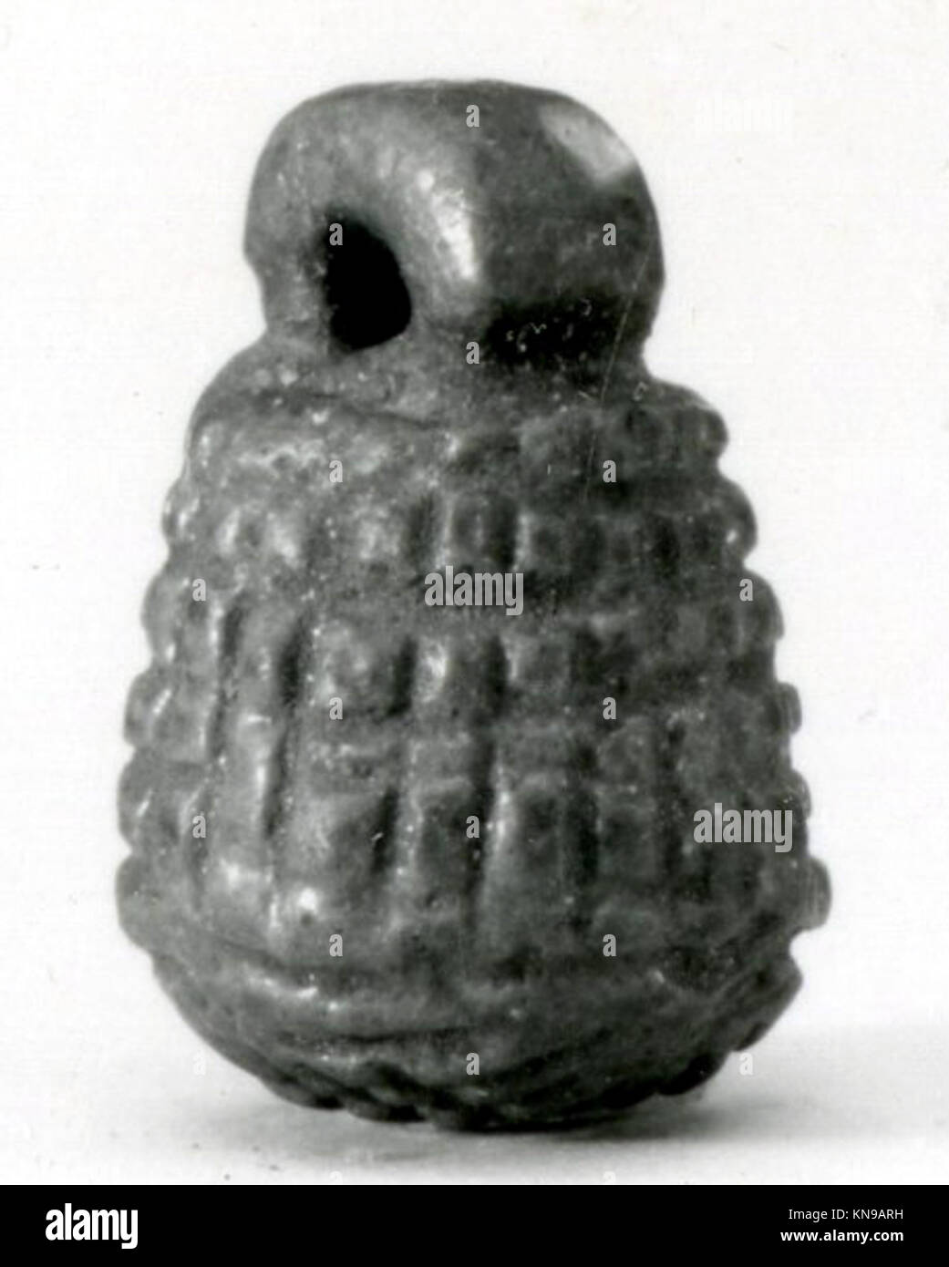 This amulet, shaped like a basket, is part of the MET collection and ...