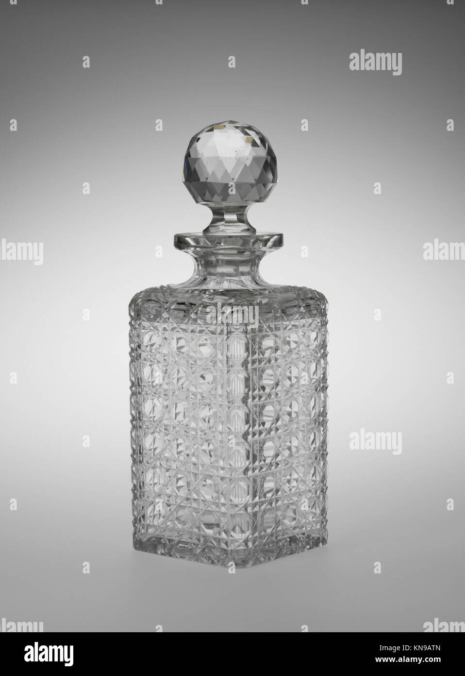 This decanter, featuring a stopper, is an elegant example of glassware ...