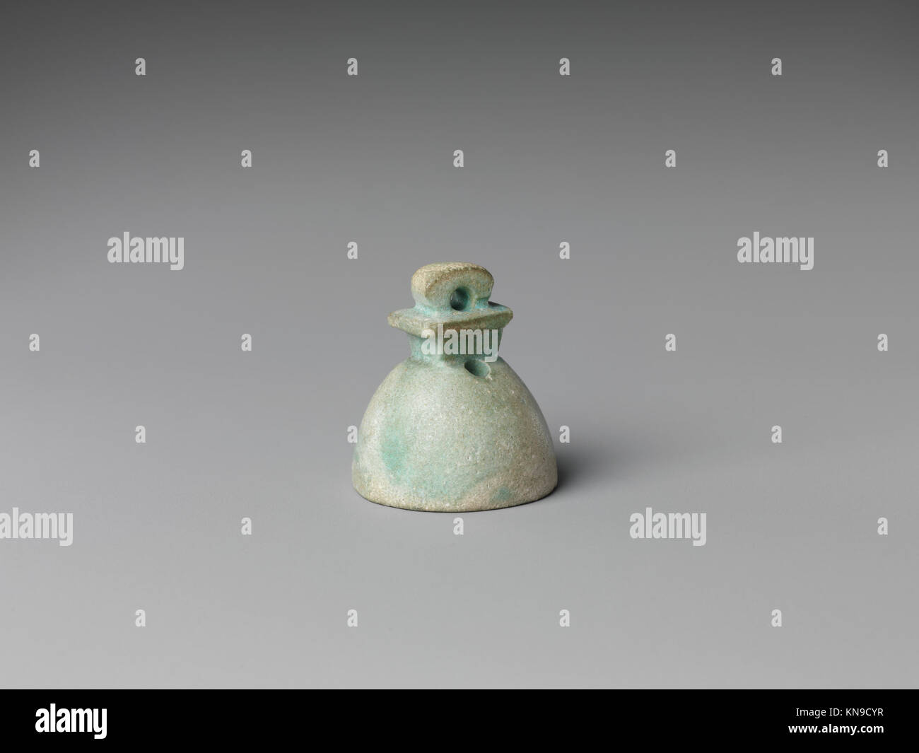 This bell, crafted from metal, features intricate designs and reflects ...