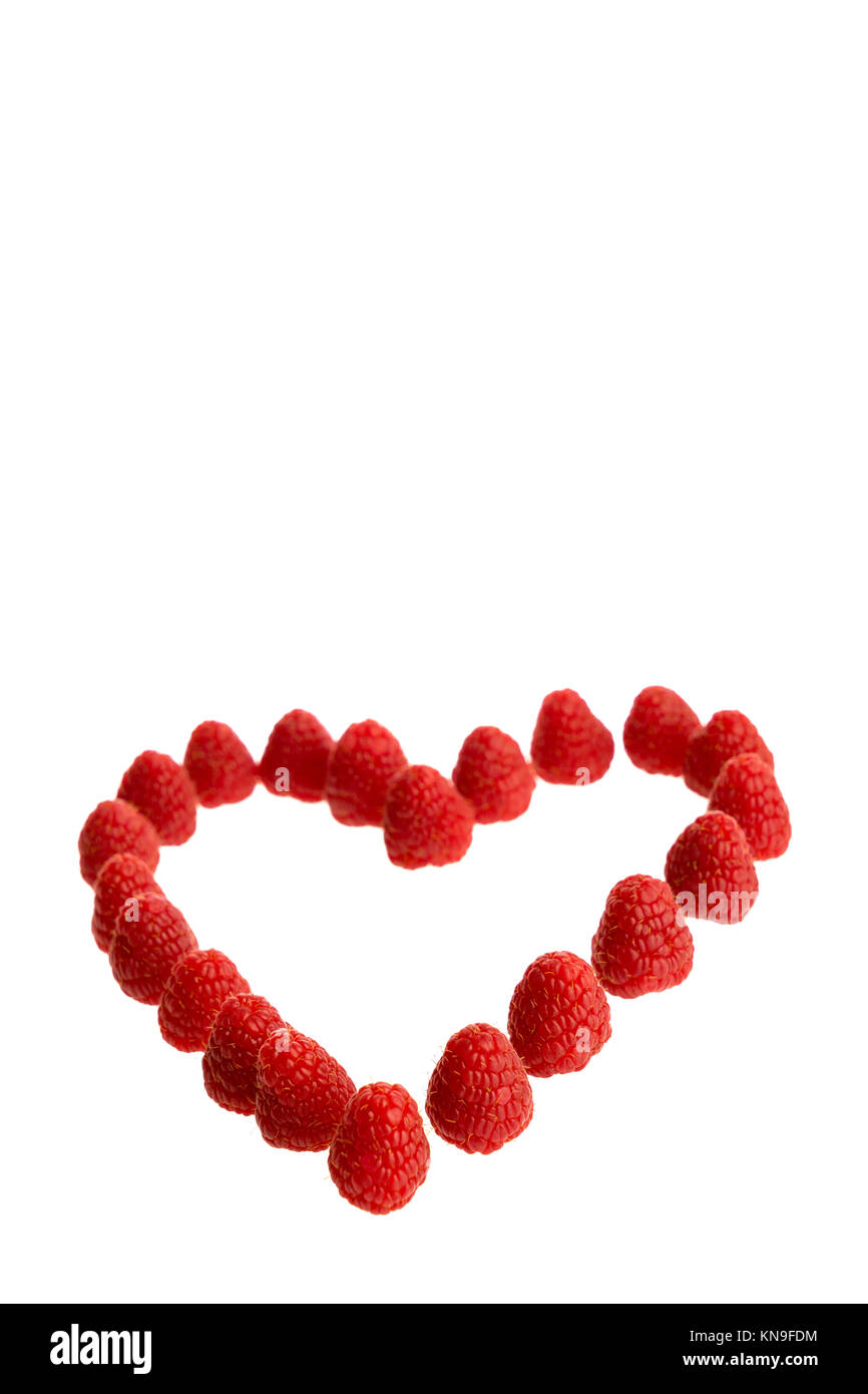 Ripe raspberries lying in a heart shape seen from above isolated in a ...