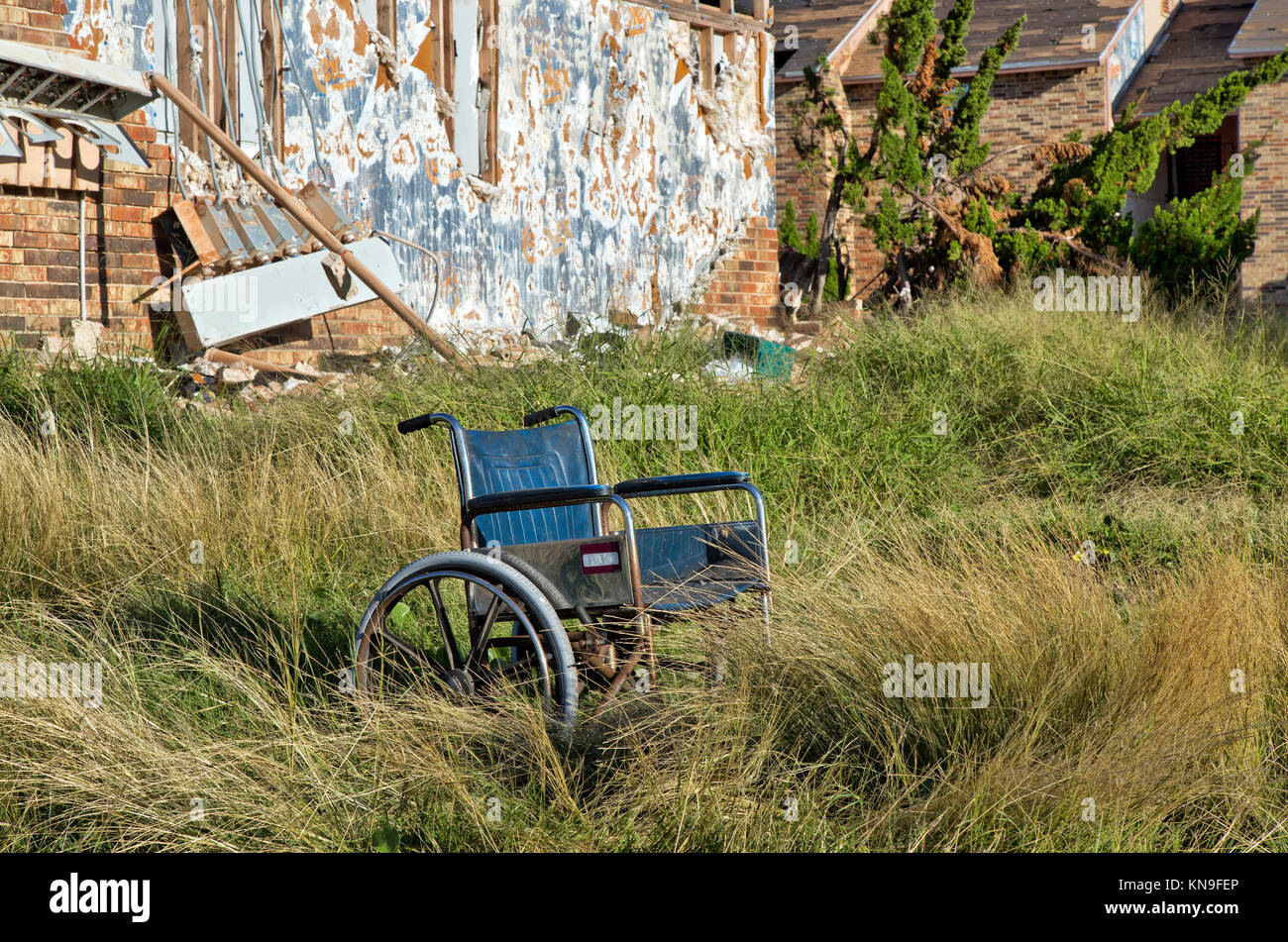 Abandoned wheelchair resting at destroyed housing complex, resulting ...