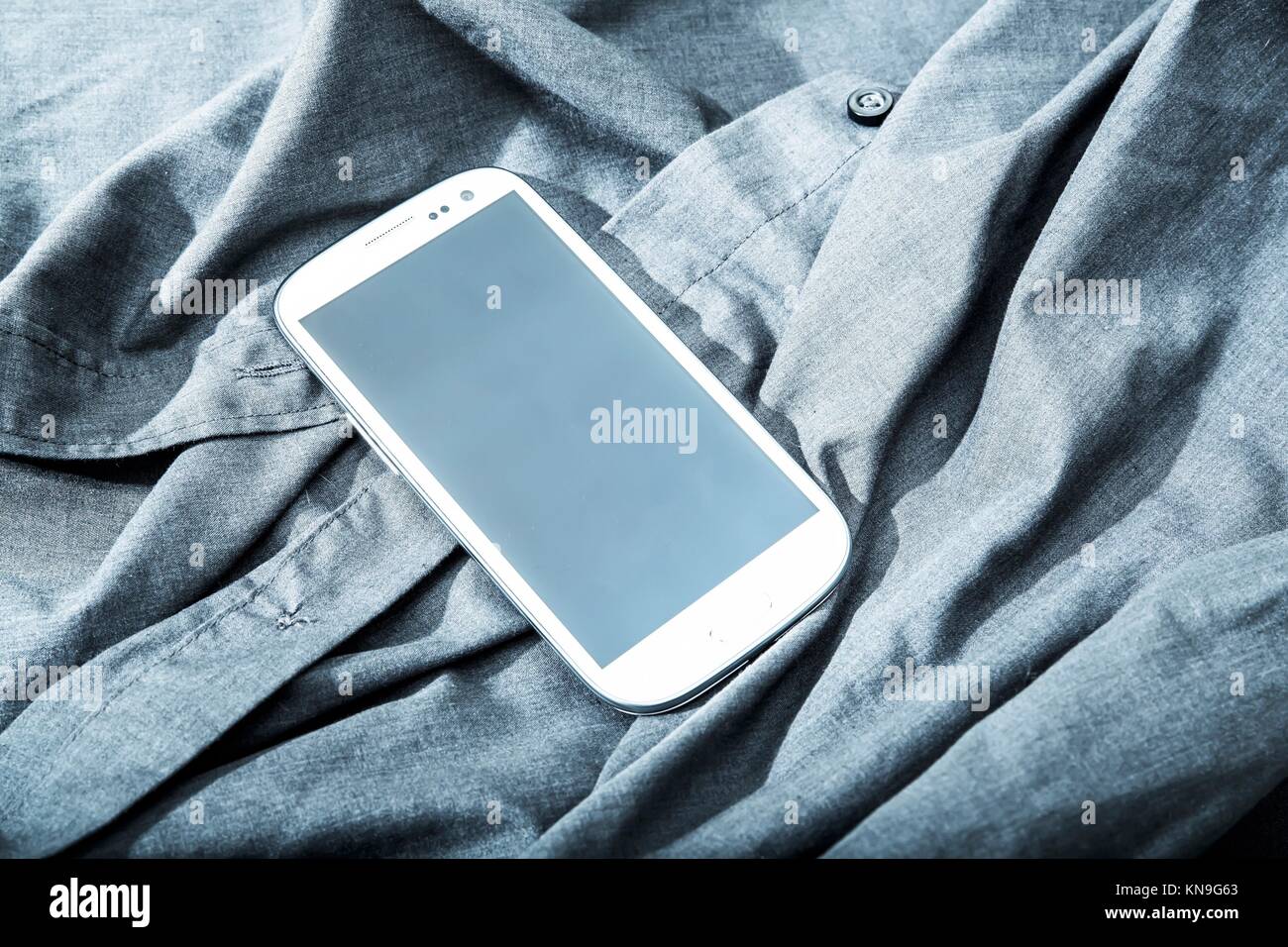 A Smartphone on some dark cloth Stock Photo - Alamy
