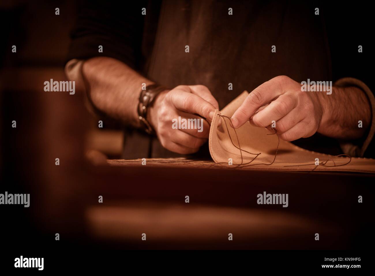 Leather goods craftsman at work in his workshop hi-res stock ...