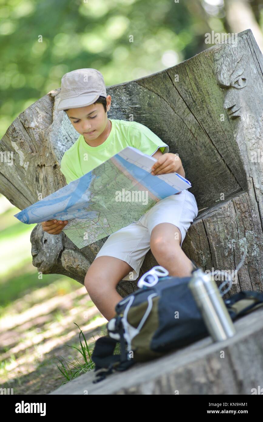 Young boy seeking his path on a map during a hike Stock Photo - Alamy