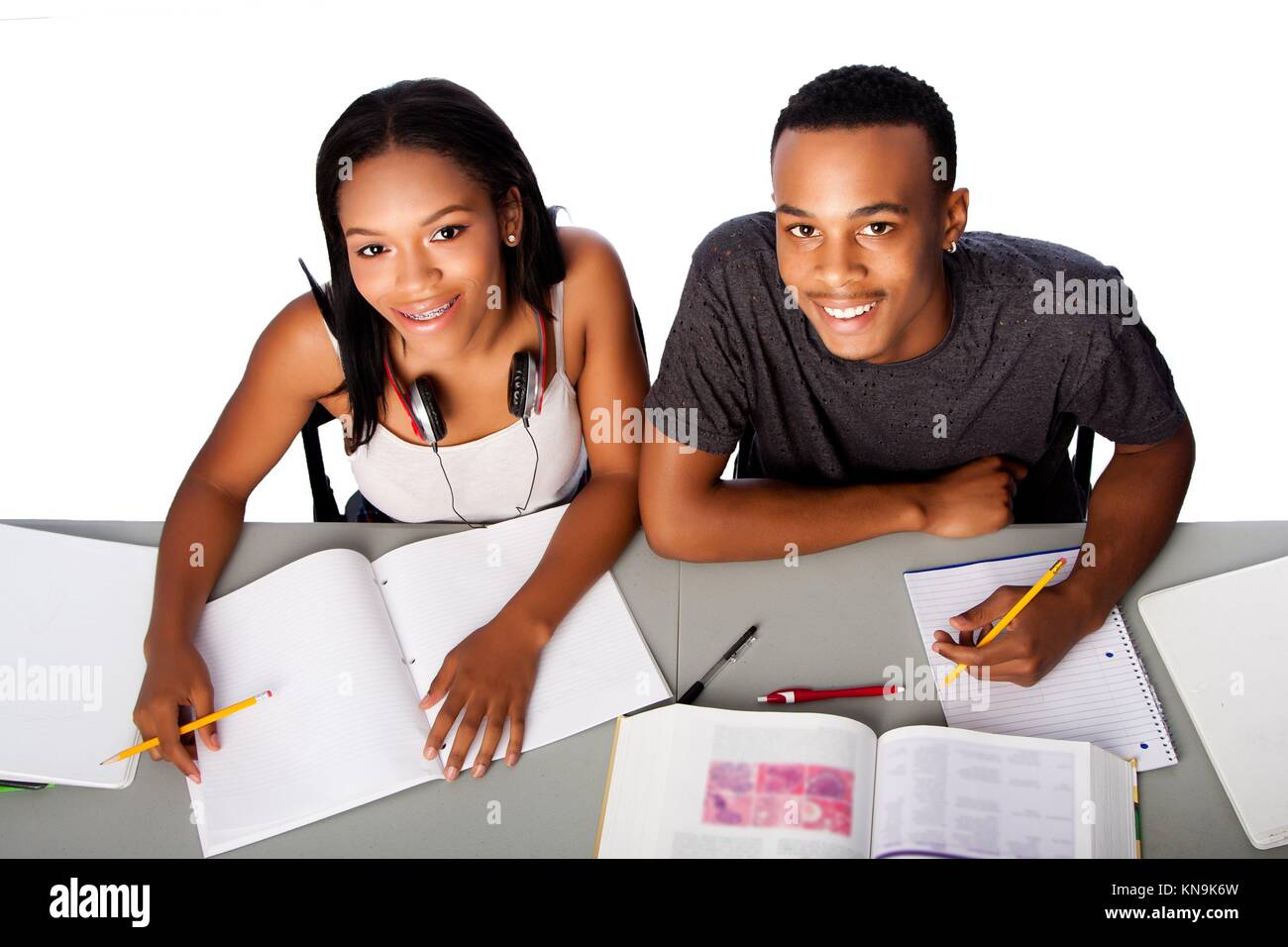 Two happy smiling academic students studying together, on white Stock ...