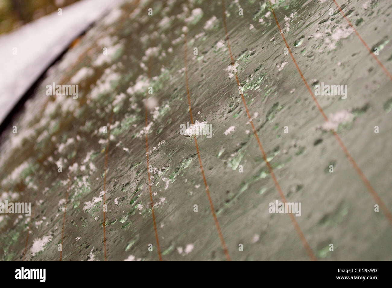 Snow falling on a rear car window Stock Photo - Alamy