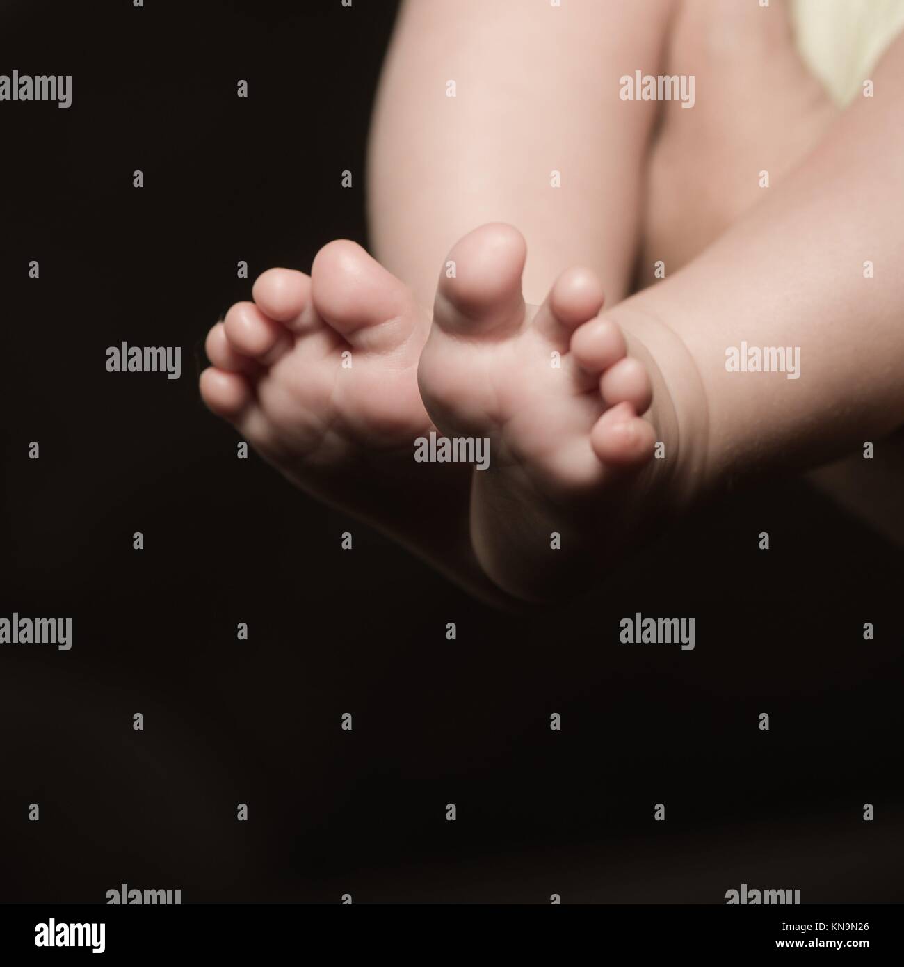 Newborn baby feet isolated on black, France Stock Photo - Alamy